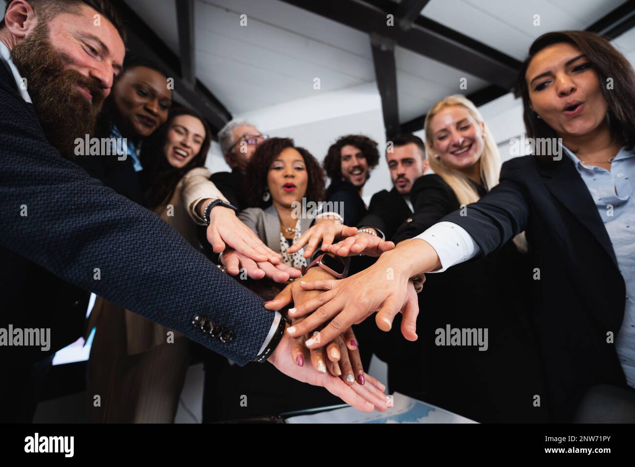 Multiracial mixed group of colleagues join hands together. Unity and ...