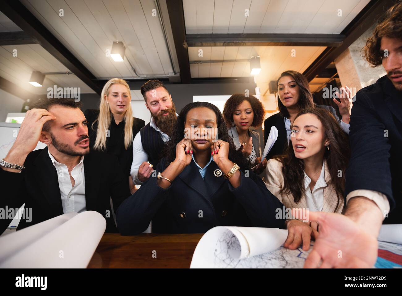 African businesswoman sitting at desk victim of bullying with ...