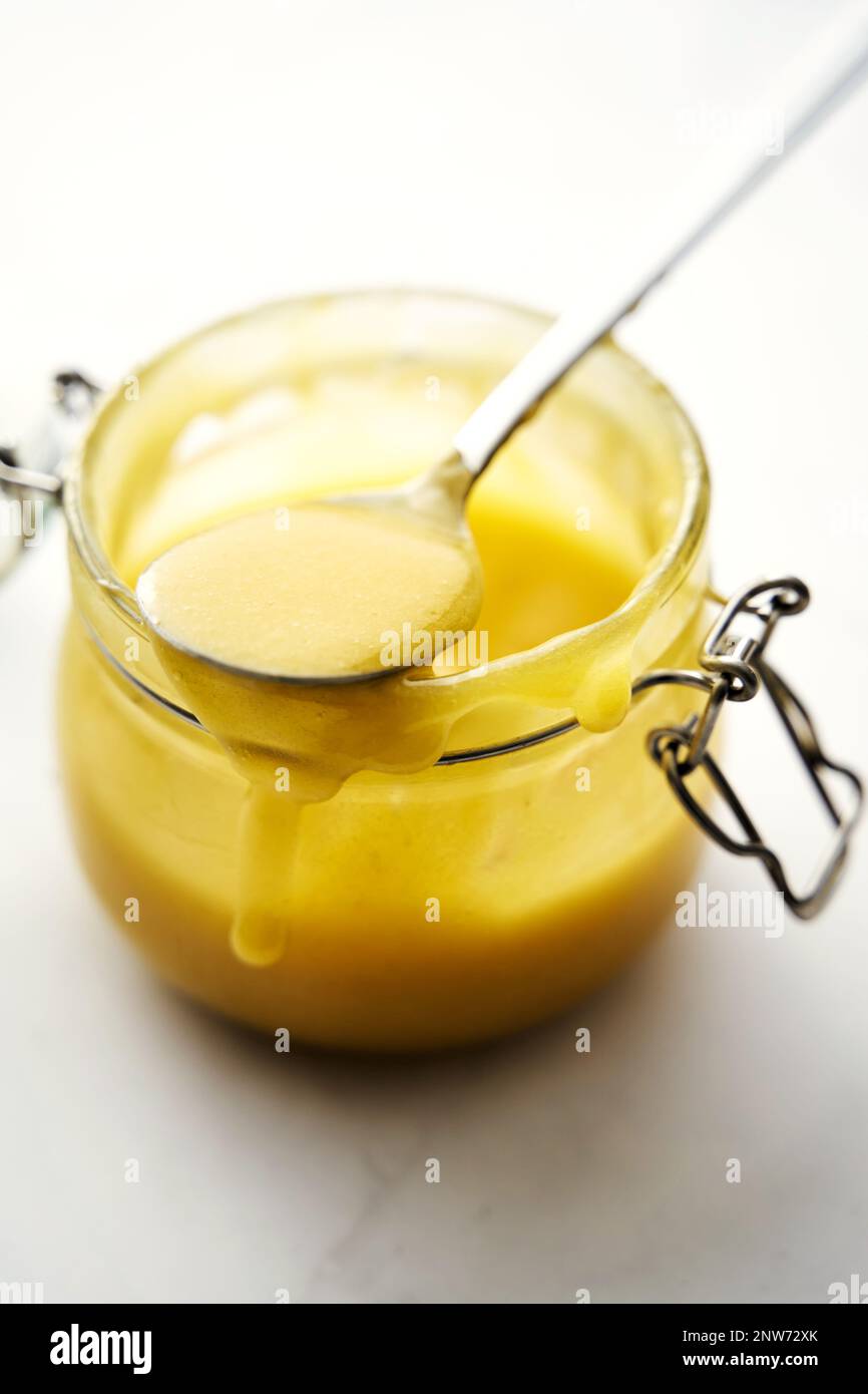 Lemon curd in a jar, spoon sticking out of the jar, top view Stock ...