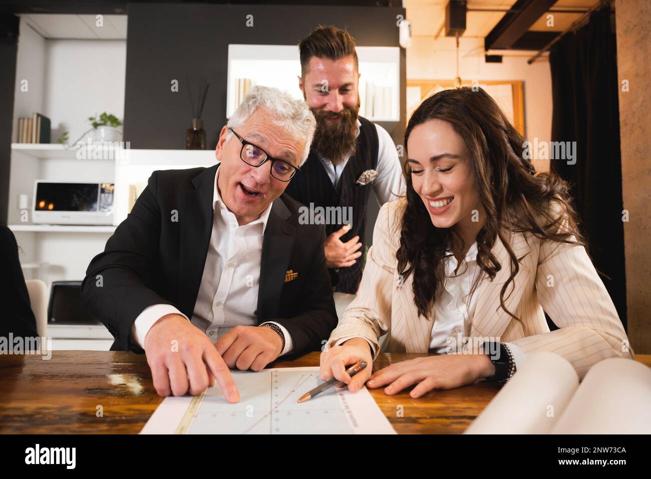 Close-up group of three colleagues discussing about work. Senior ...