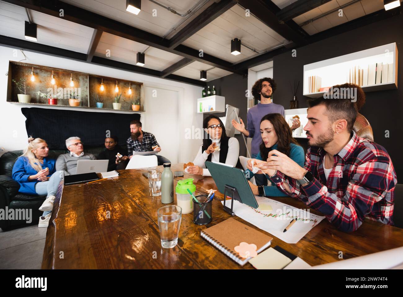 wide angle group of mixed race people working or studying together in a ...