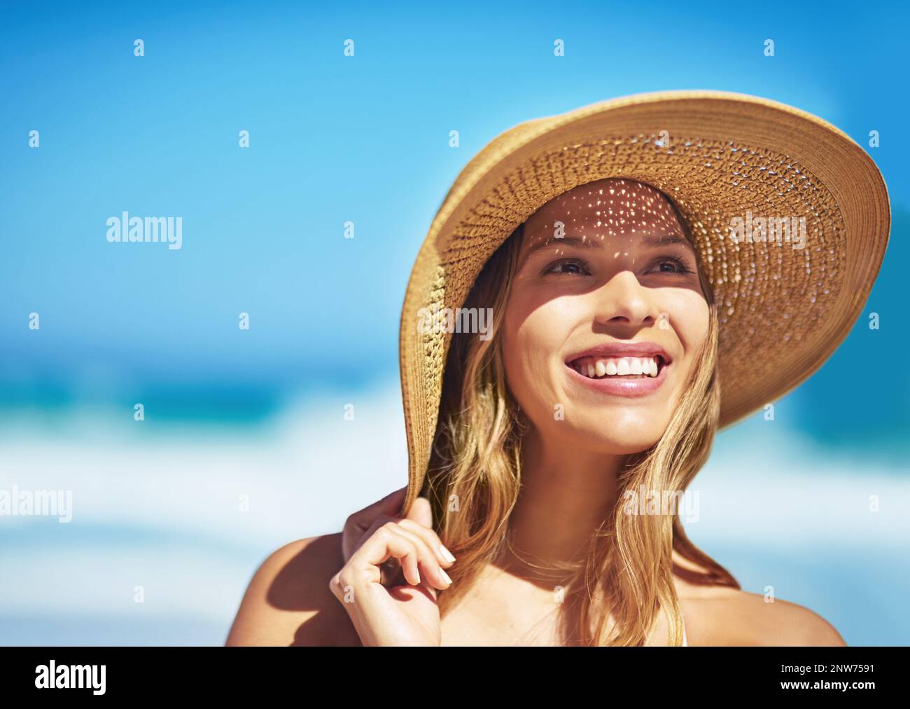 What an amazing summers day. Shot of a gorgeous young woman in a bikini ...