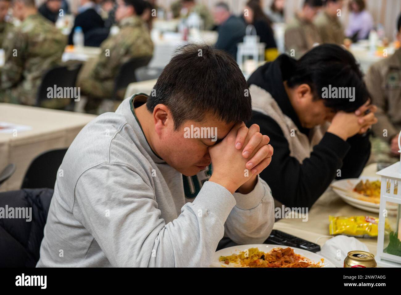 A Korean Service Corps member bow his head in prayer during U.S. Army ...