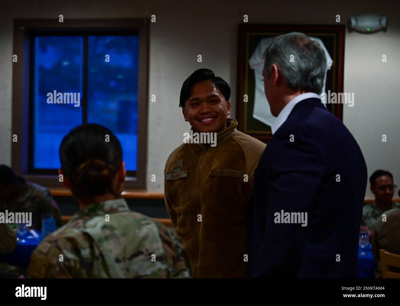 An Airman (center) speaks with Retired Brig. Gen. Jeremy Sloane, ‘Wolf ...