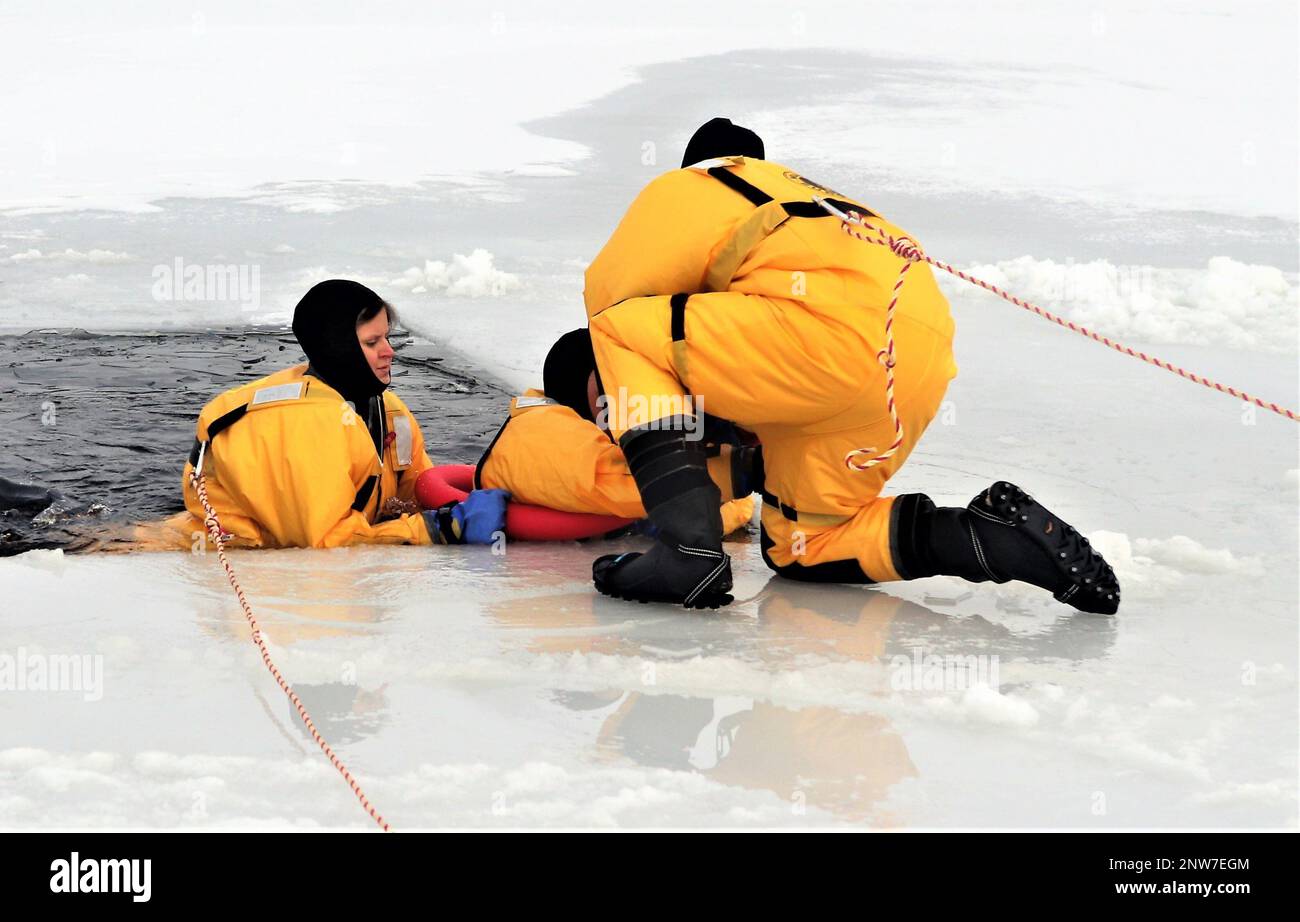 Firefighters wearing cold-water immersion protective suits hold surface ...