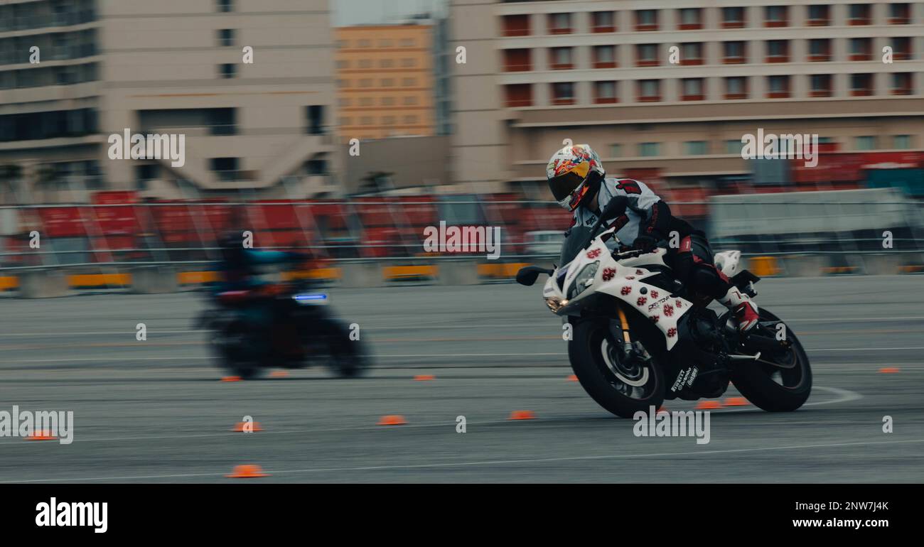A U.S. service member rides their motorcycle through a training circuit ...