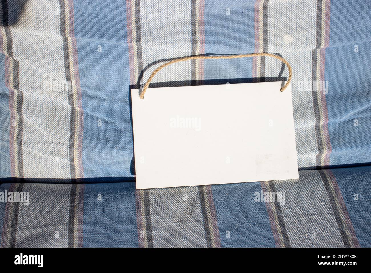 blue and white striped material and a white hanging picture sign with ...