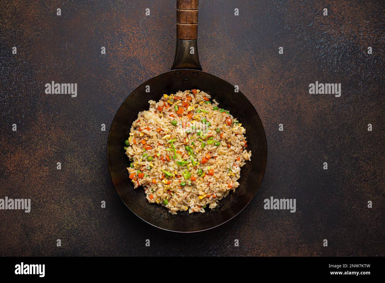 Authentic Chinese and Asian fried rice with egg and vegetables in wok ...
