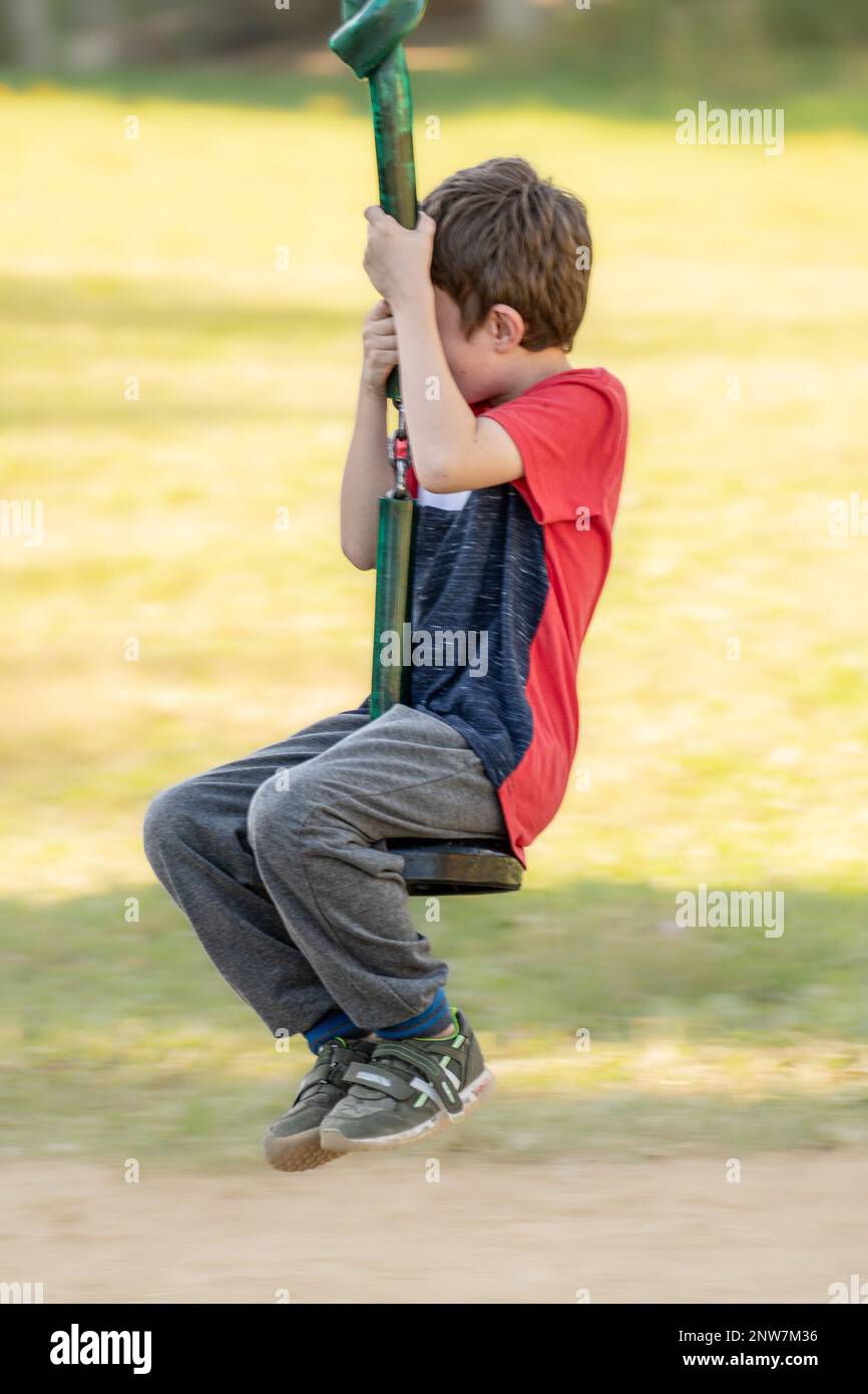 Child having fun on the zip line in the park Stock Photo - Alamy