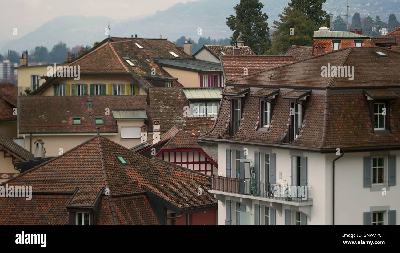 Traditional European building rooftop with Chimney smoke. Swiss ...