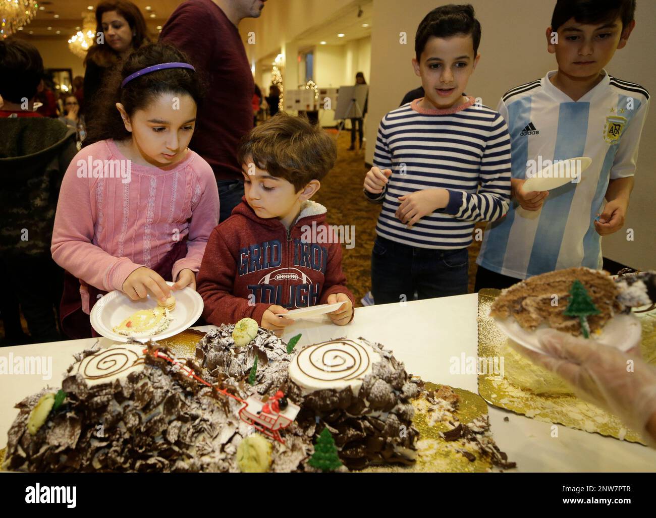 In a Saturday, Dec. 8, 2018 photo, Lana Attar, 10, left, and her ...
