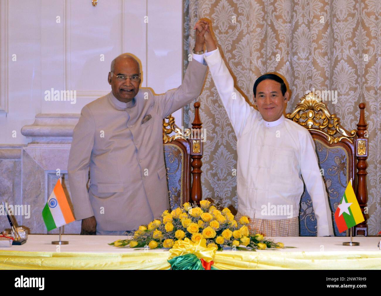 Myanmar's President Win Myint, right, holds the hand of Indian ...