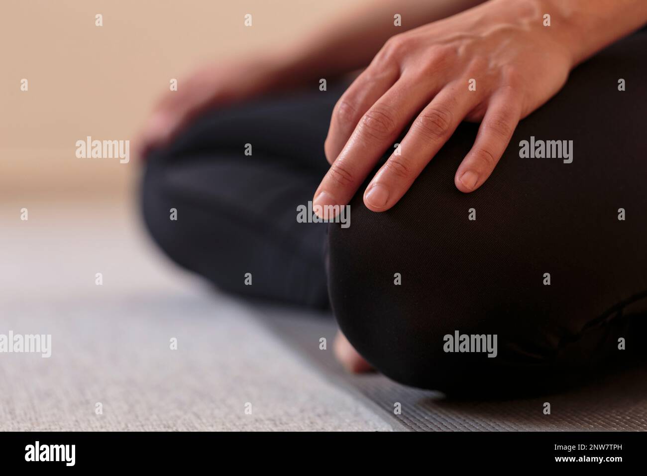 Horizontal side closeup of lower body of yogini on the floor with legs ...
