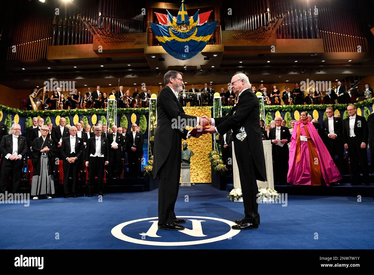 Chemistry laureate George P. Smith, left, receives the prize from King ...