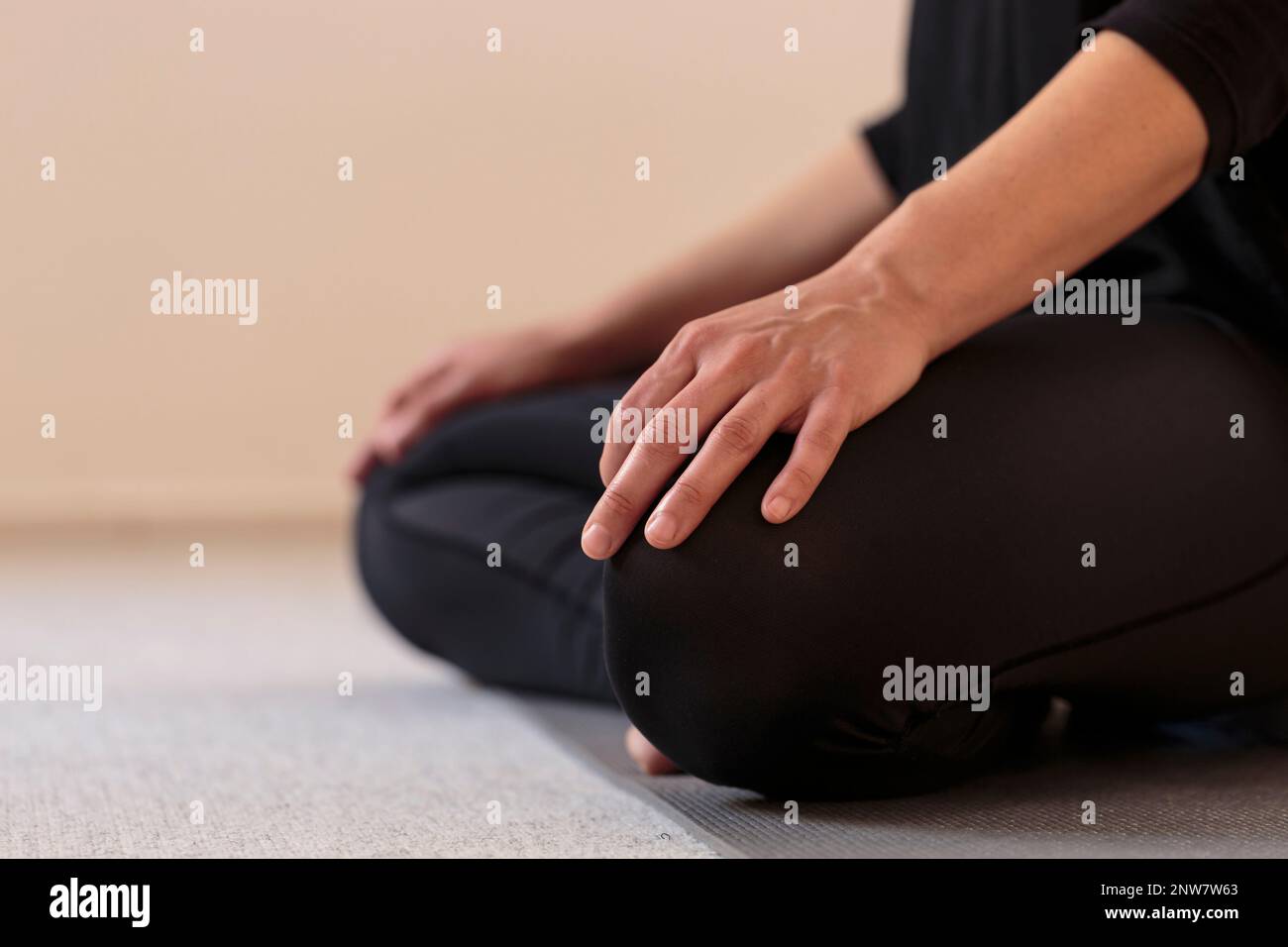 Horizontal side closeup of lower body of yogini on the floor with legs ...
