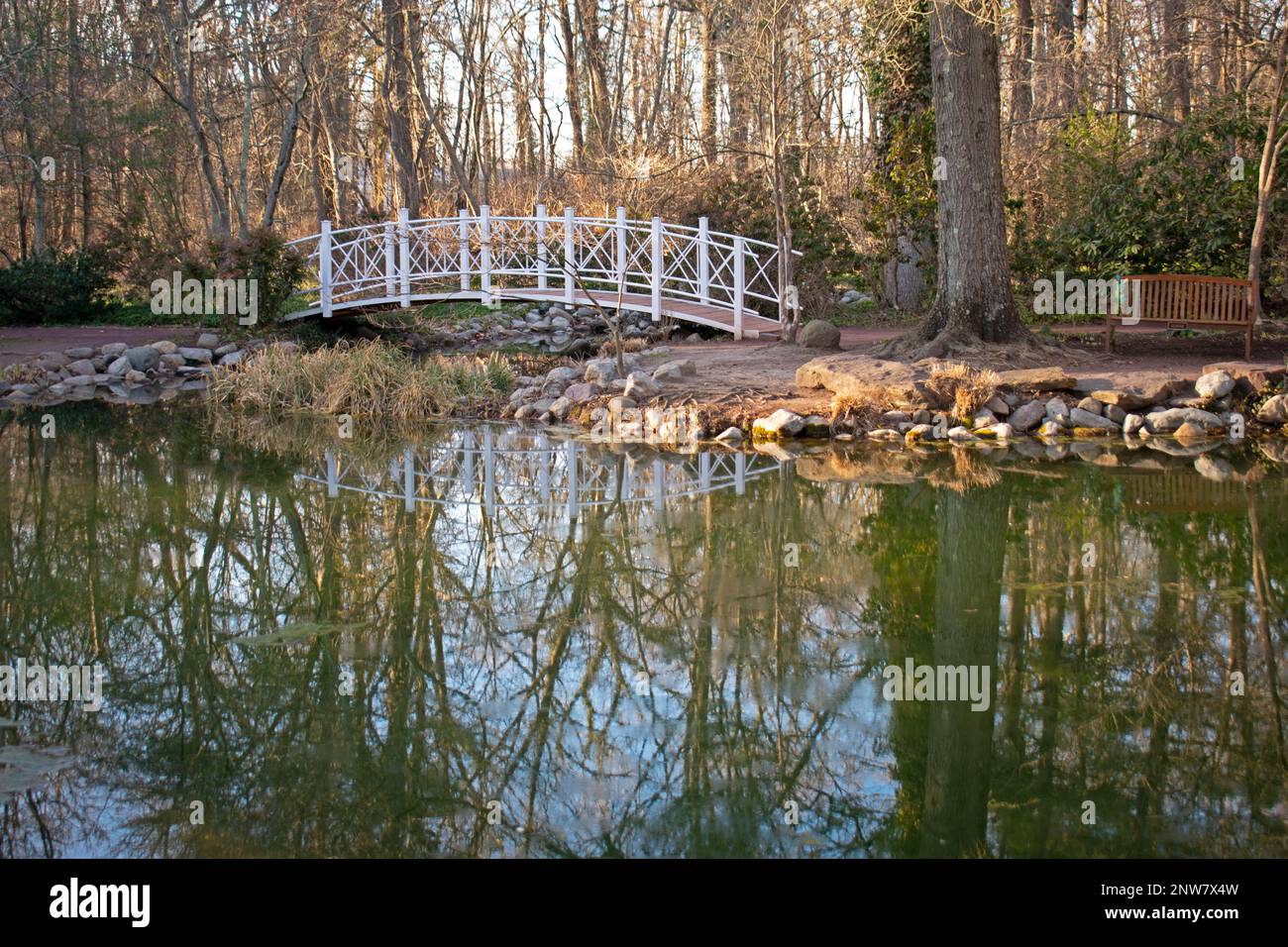 Scenic view of a small bridge crossing over a pond in Sayen Gardens ...
