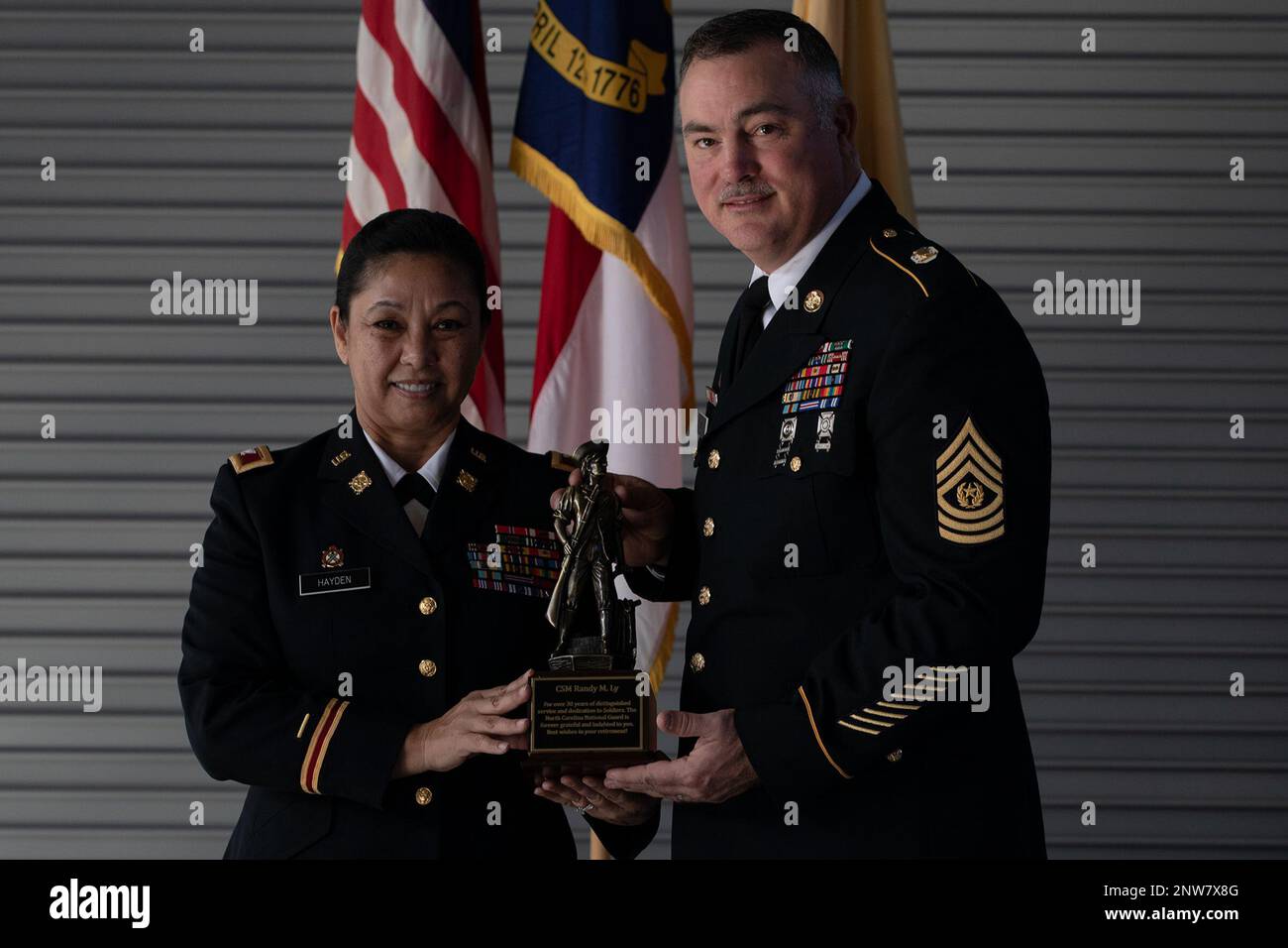 Command Sgt. Maj. Randy Ly, right, completes his last official duty for ...