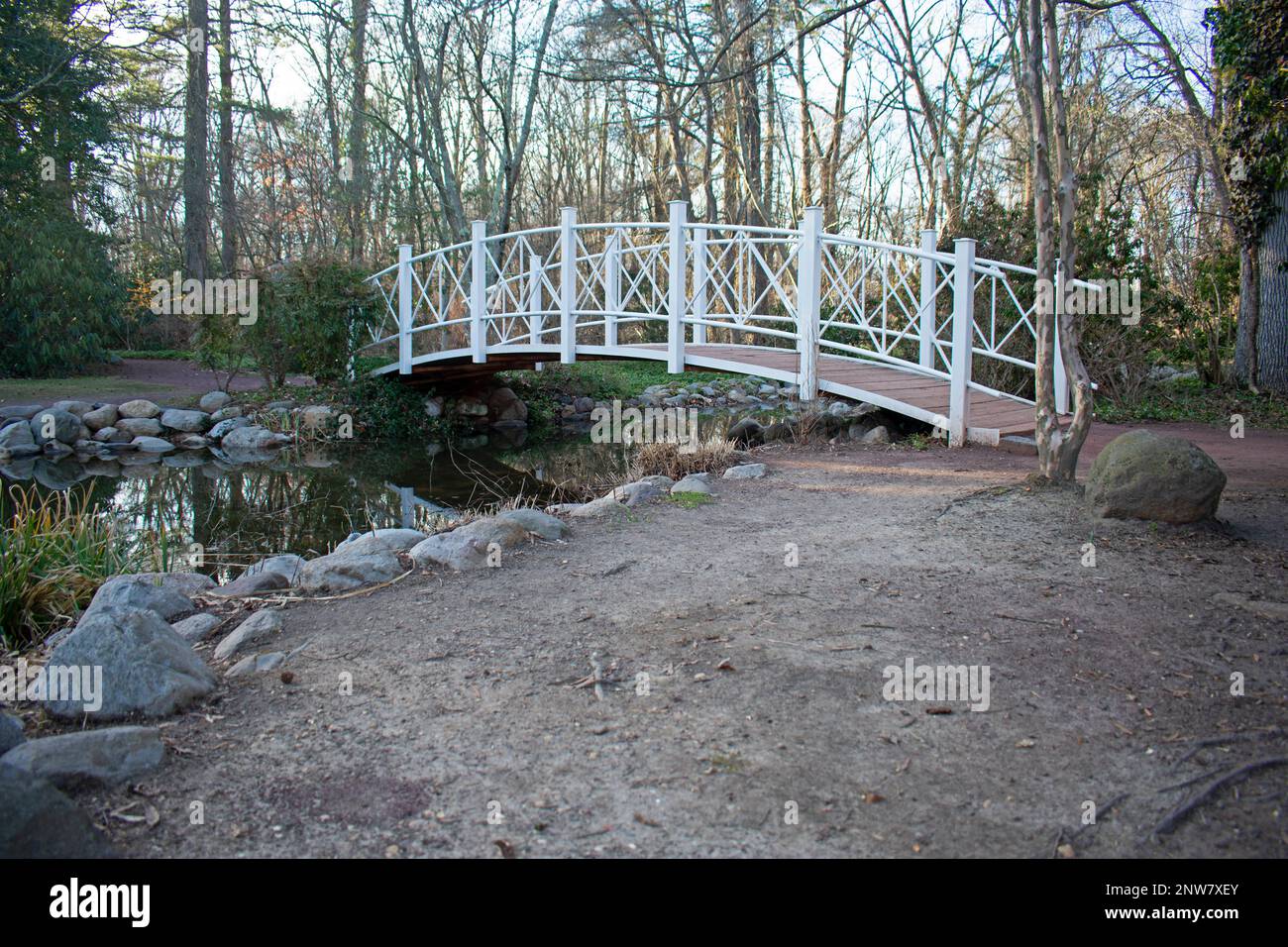 Scenic view of a small bridge crossing over a pond in Sayen Gardens ...