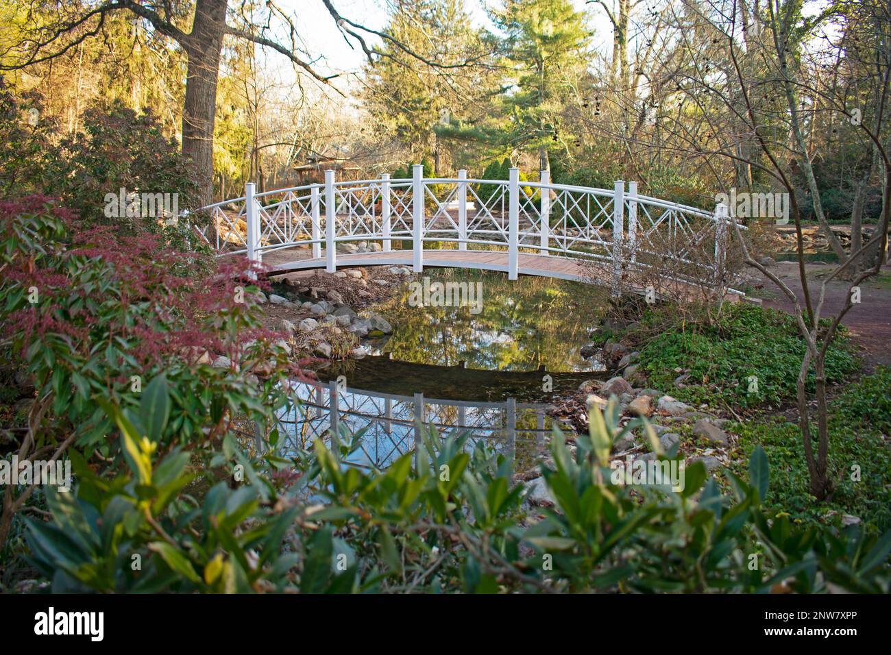 Scenic view of a small bridge crossing over a pond in Sayen Gardens ...