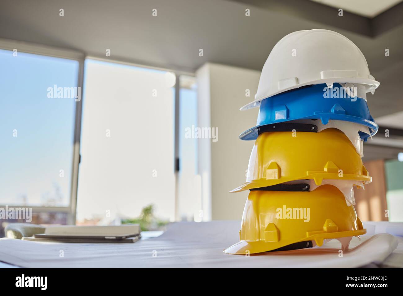Building, helmets and architect equipment on table for construction ...