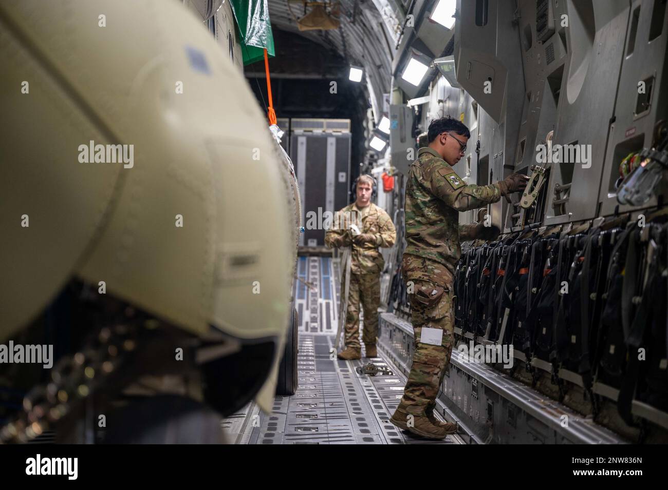 Senior Airman Frankie Arceo, 3rd Airlift Squadron loadmaster, prepares ...