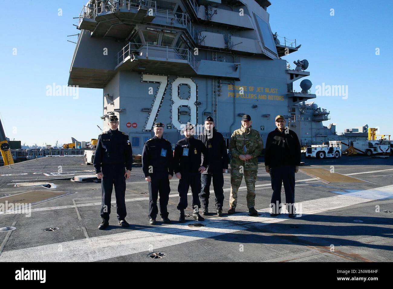 USS Gerald R. Ford (CVN 78) Command Master Chief Bryan Davis, right ...