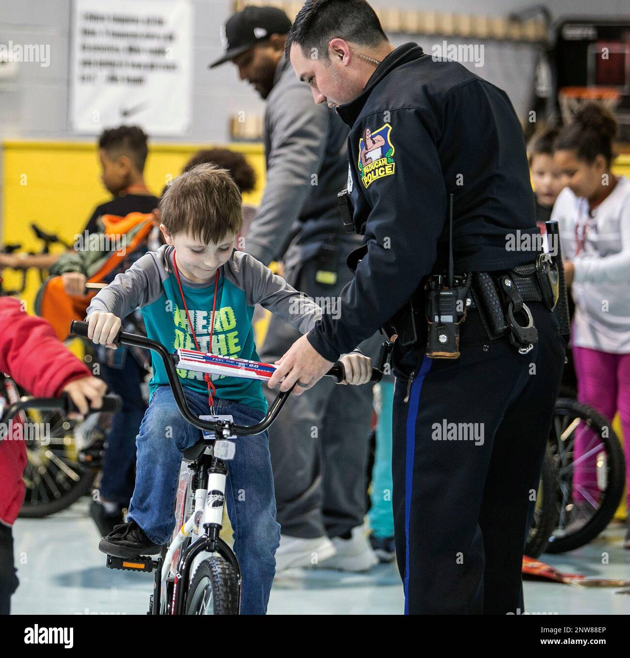 Officer Danny Slack, of the Paducah Police Department, helps Brylan ...
