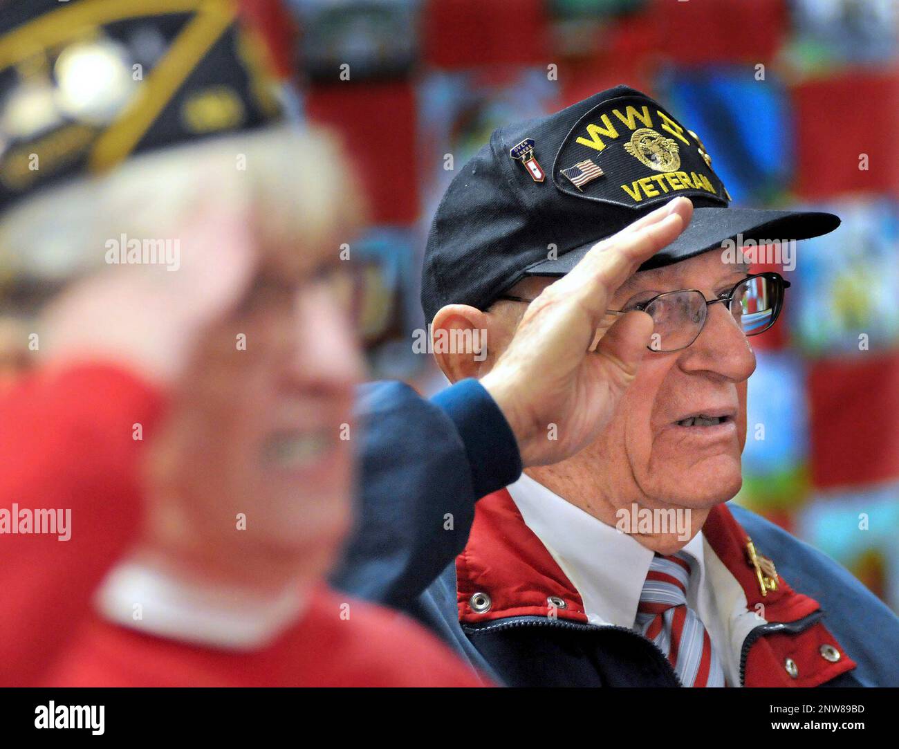 World War II veteran Caster Salemi, 96, salutes during the "Pledge of ...