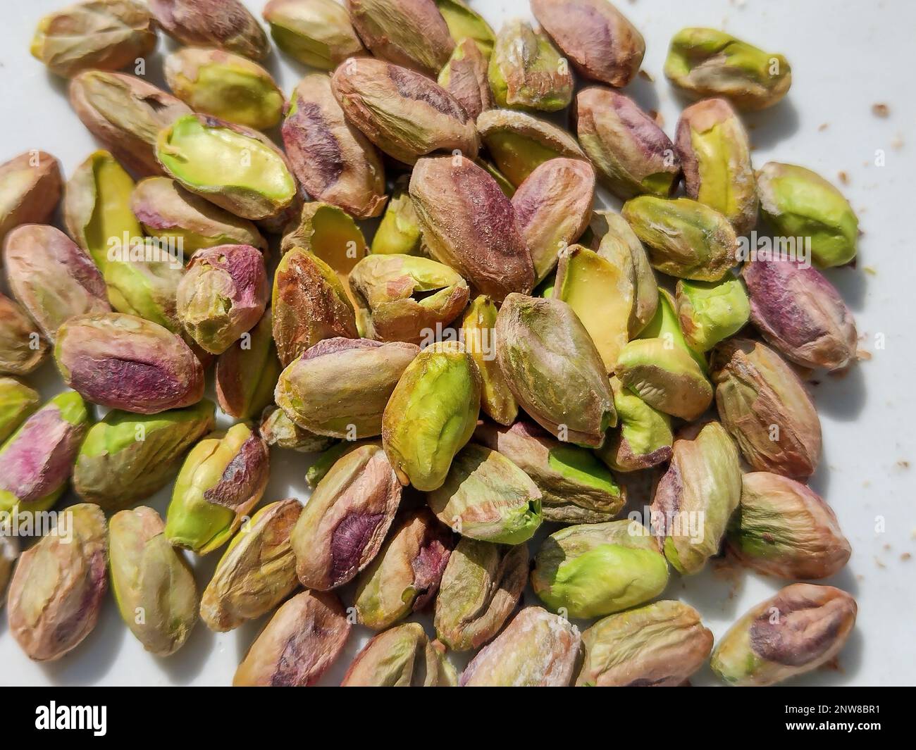 peeled pistachios isolated on white background Stock Photo - Alamy