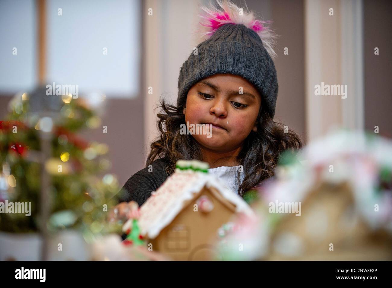 Debbie Morales, 8, decorates her gingerbread house at the 6th annual ...