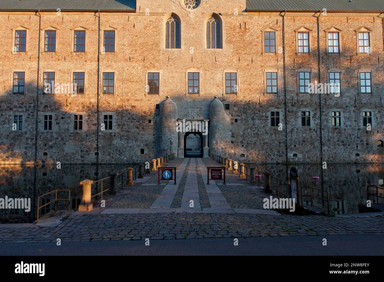 Vadstena Castle facade, wall, and moat on this side. View from outside ...