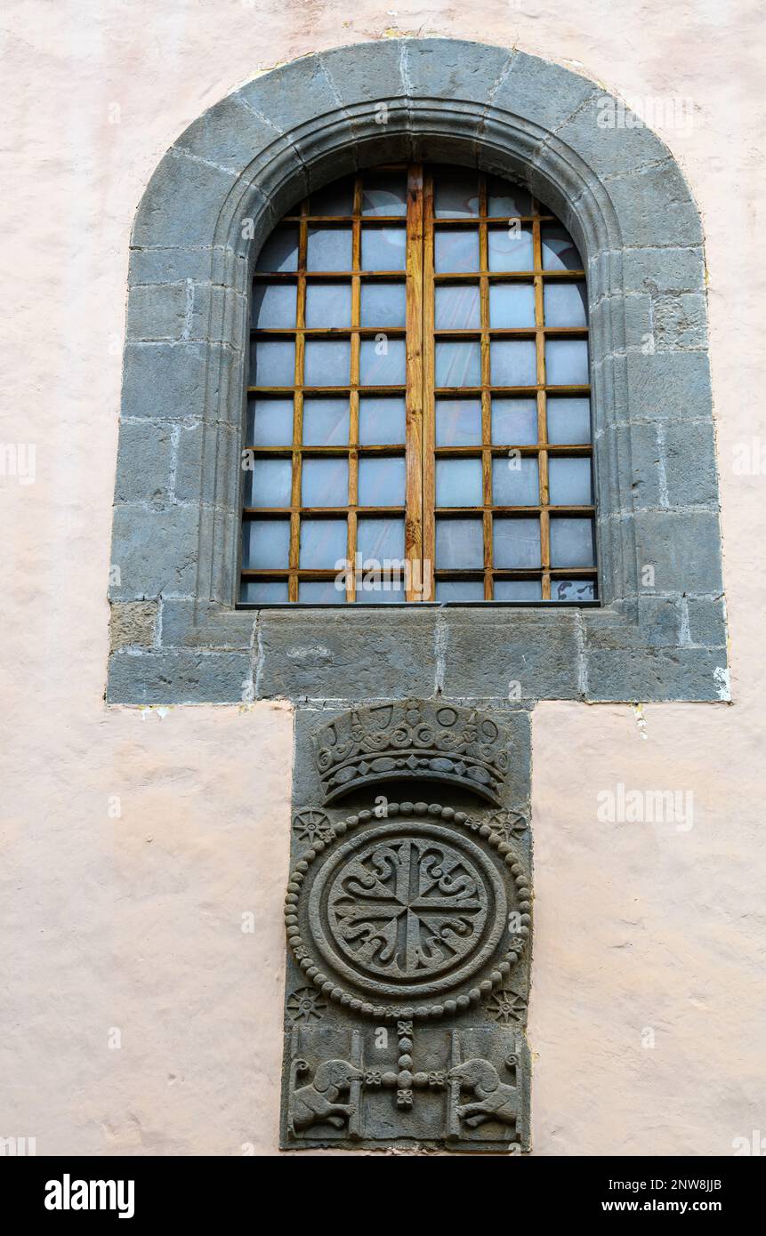A stone arched window and the crest of the Dominican Order above the ...