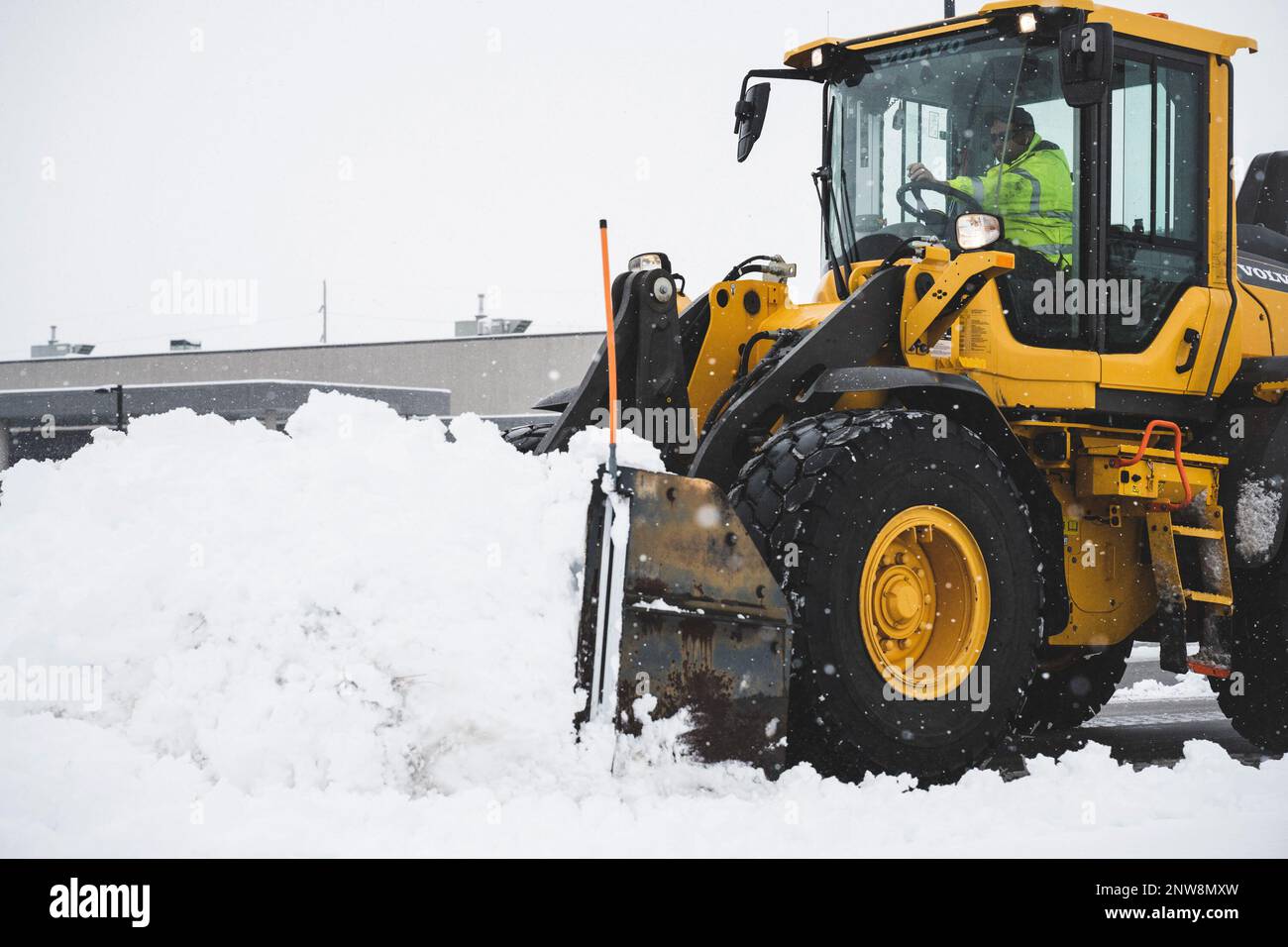 A snowplow operator from the 88th Civil Engineer Squadron clears the ...