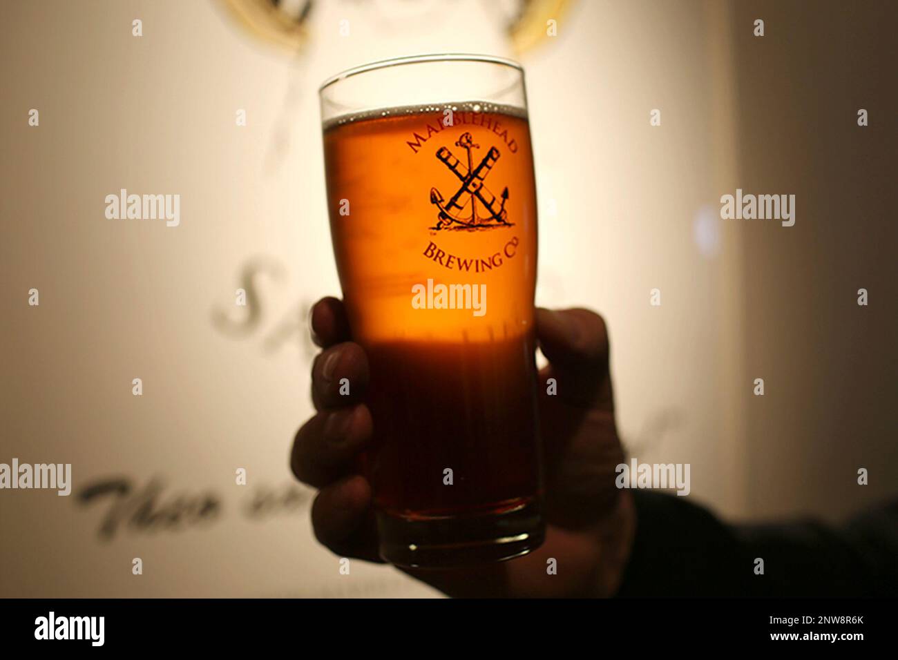In this undated mage, Father Andrew Bushell holds a glass of Marblehead ...