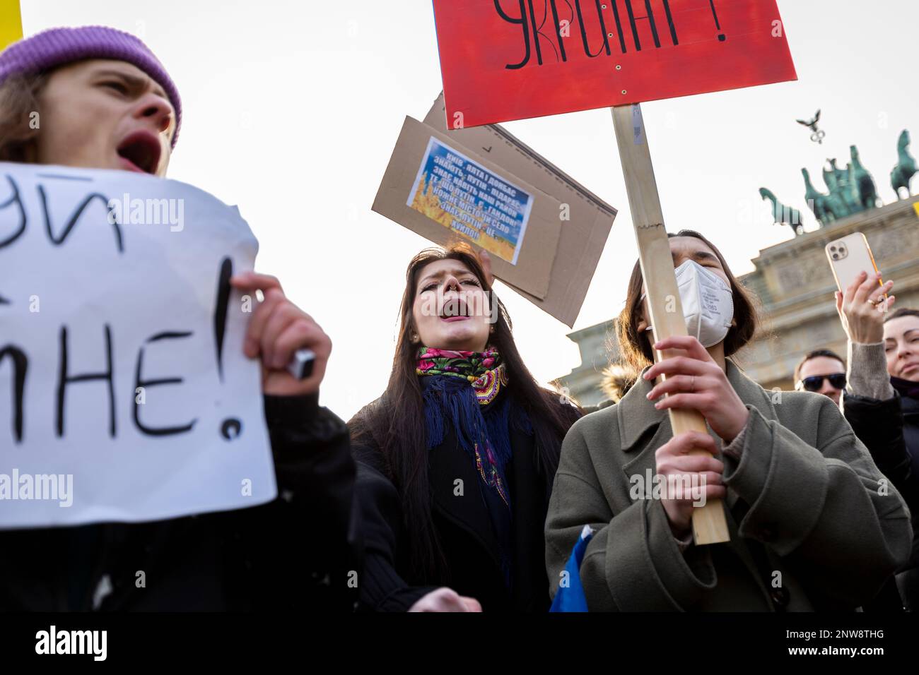 02-27-22 A group of young protesters with makeshift banners shout anti ...