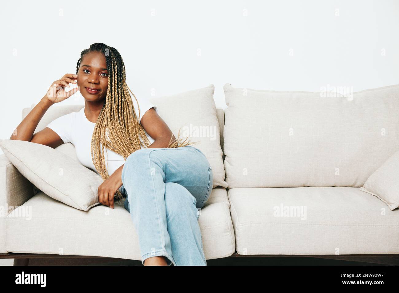 Happy african american woman sitting at home on sofa, rest and vacation ...