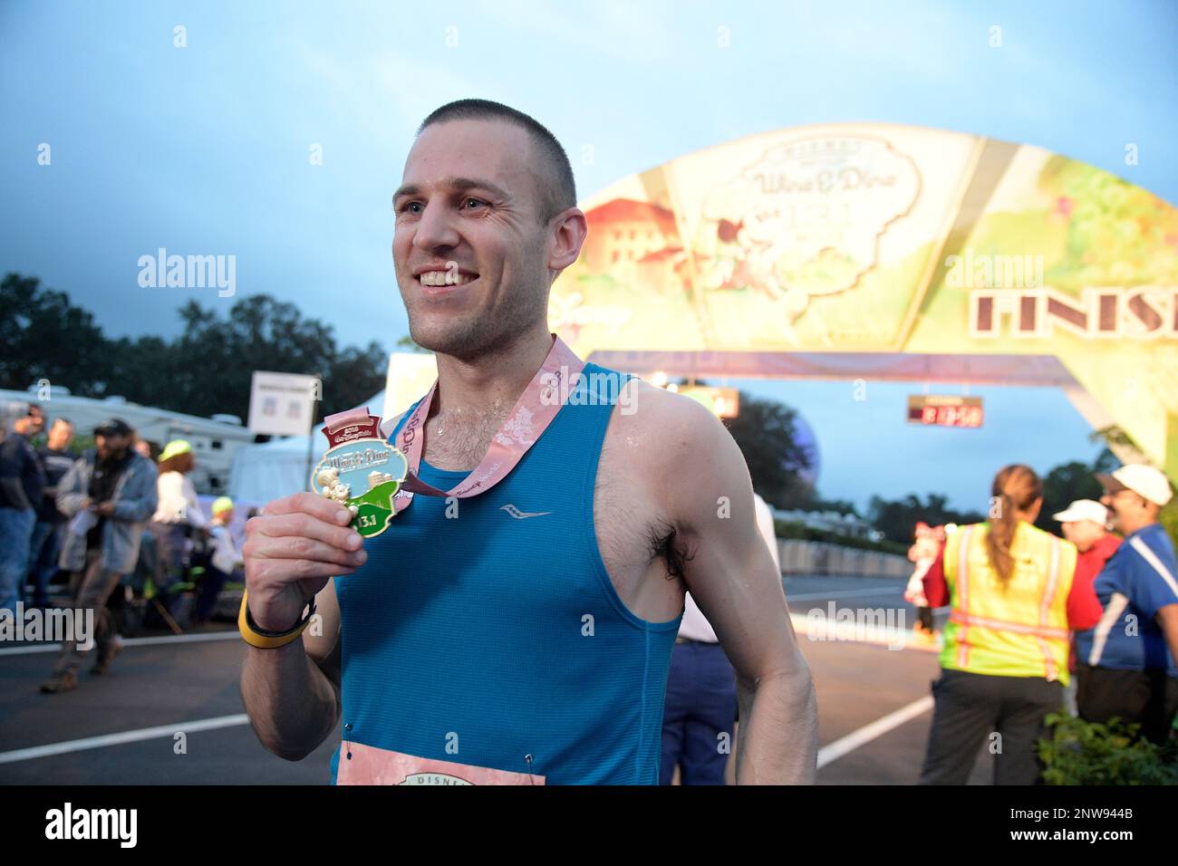 Tyler Watson holds his medal after winning the Disney Wine & Dine Half ...