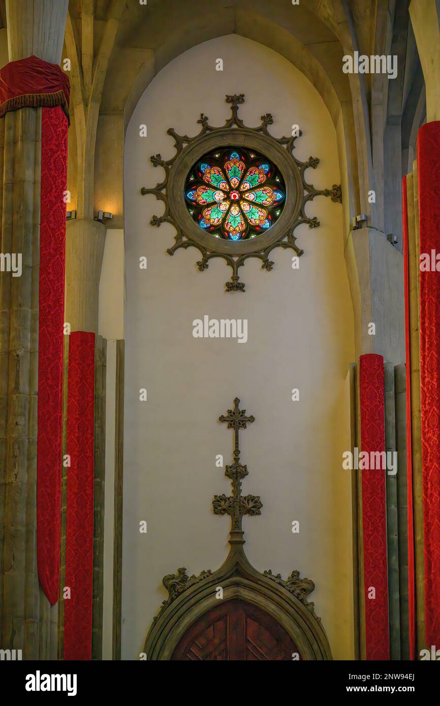 A colourful circular stained-glass window over the side entrance to the ...