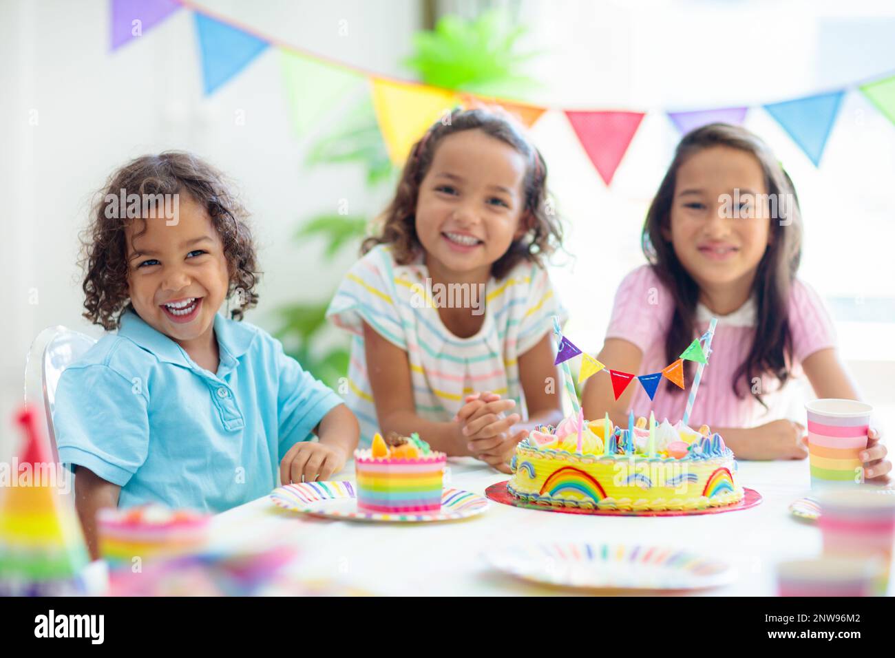 Kids birthday party. Children celebrate with colorful cake and gifts ...