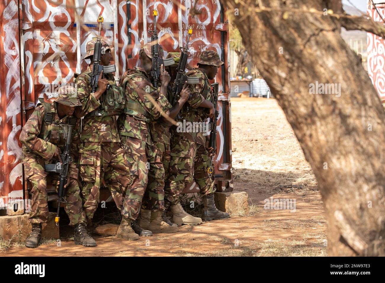 Soldiers from the Kenya Defence Forces prepare to enter a building during a Situational Training ...