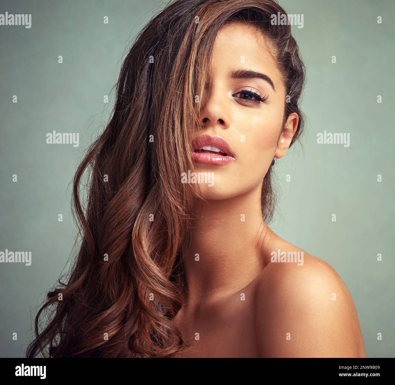Lucious locks. Studio portrait of a beautiful woman with long locks ...