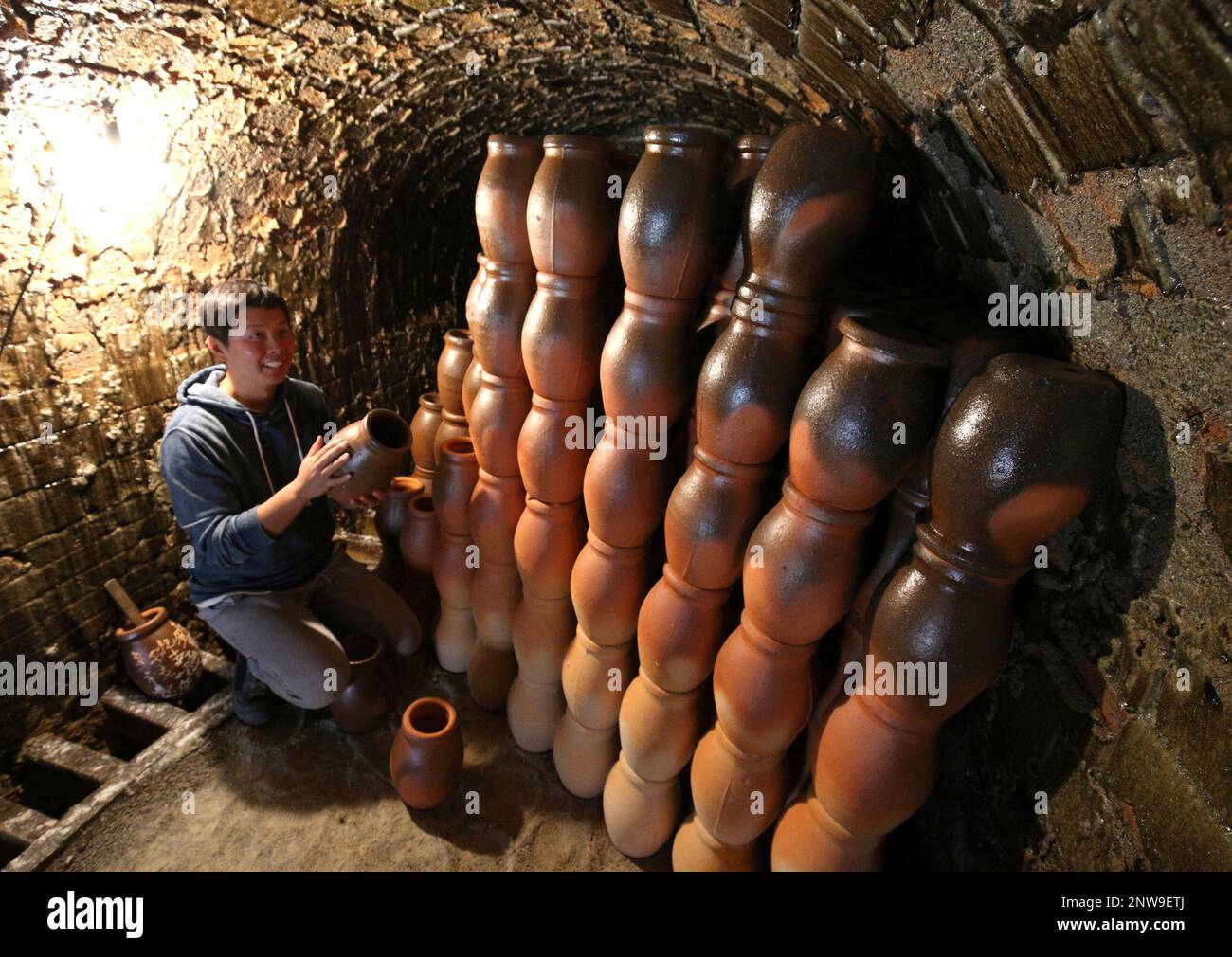 A craftsman checks baked octopus-traps at Tanaka Yogyo in Hofu ...