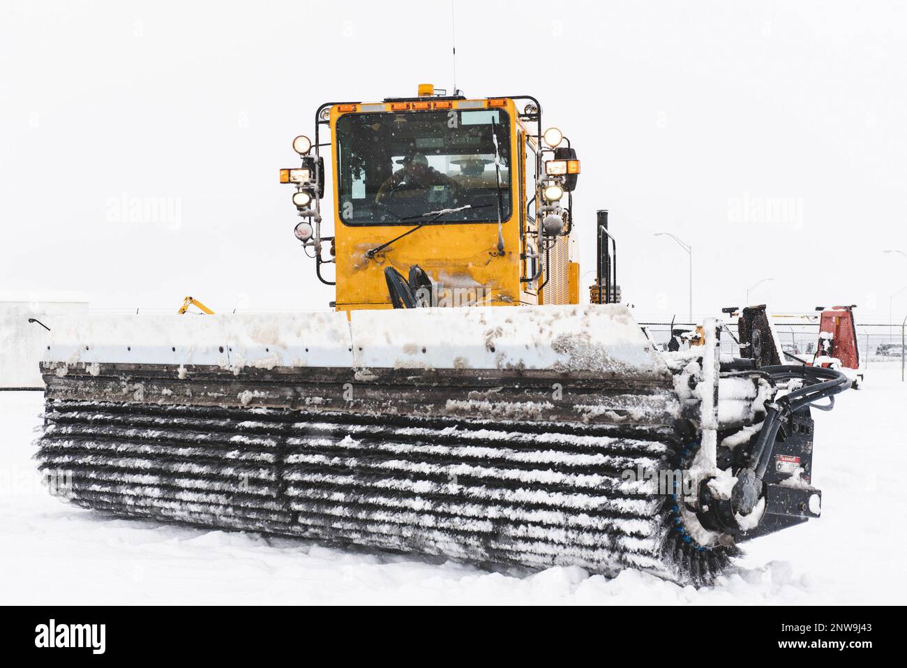 A snowplow operator from the 88th Civil Engineer Squadron clears roads ...