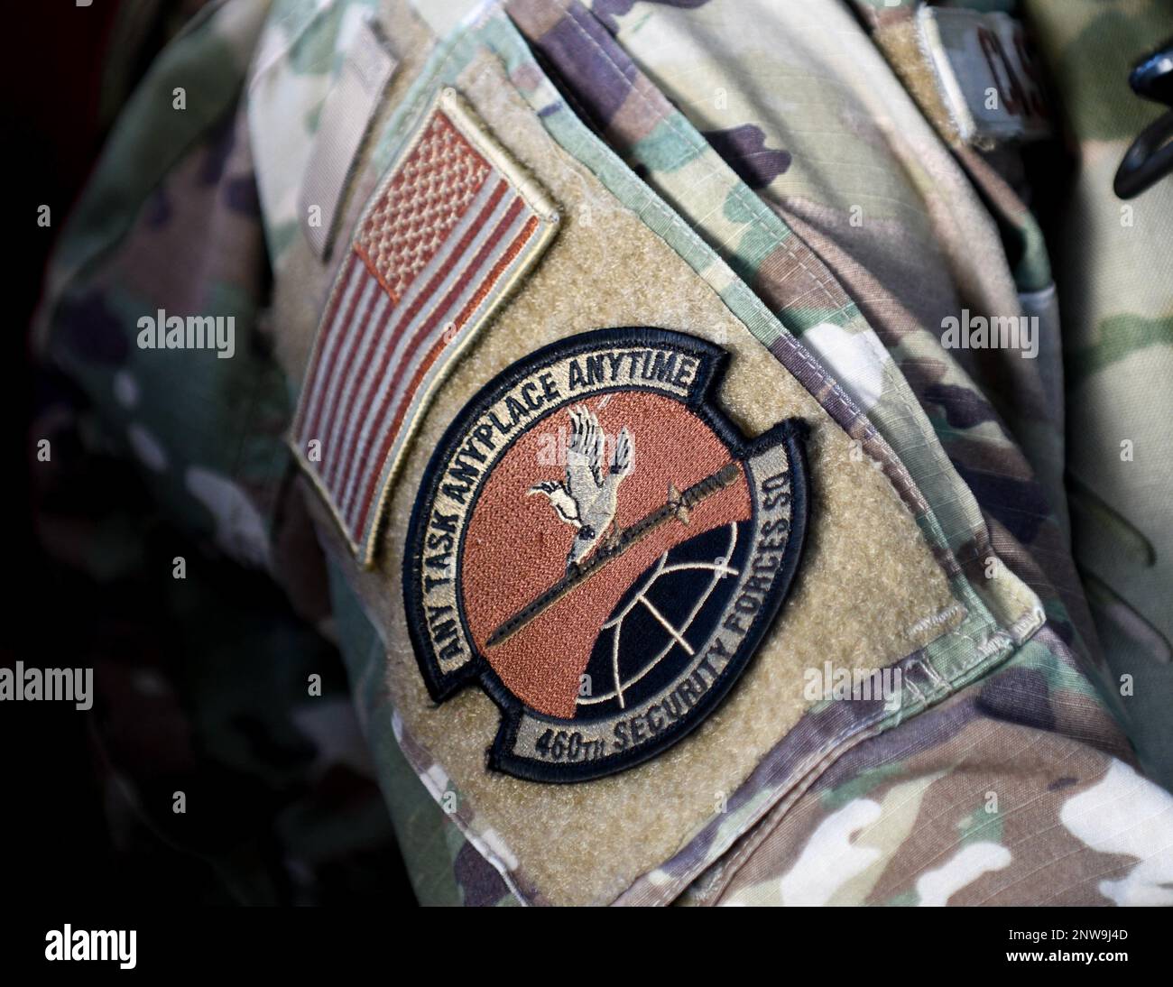 A patch reading "Any Task Anyplace Anytime, 460th Security Forces SQ ...