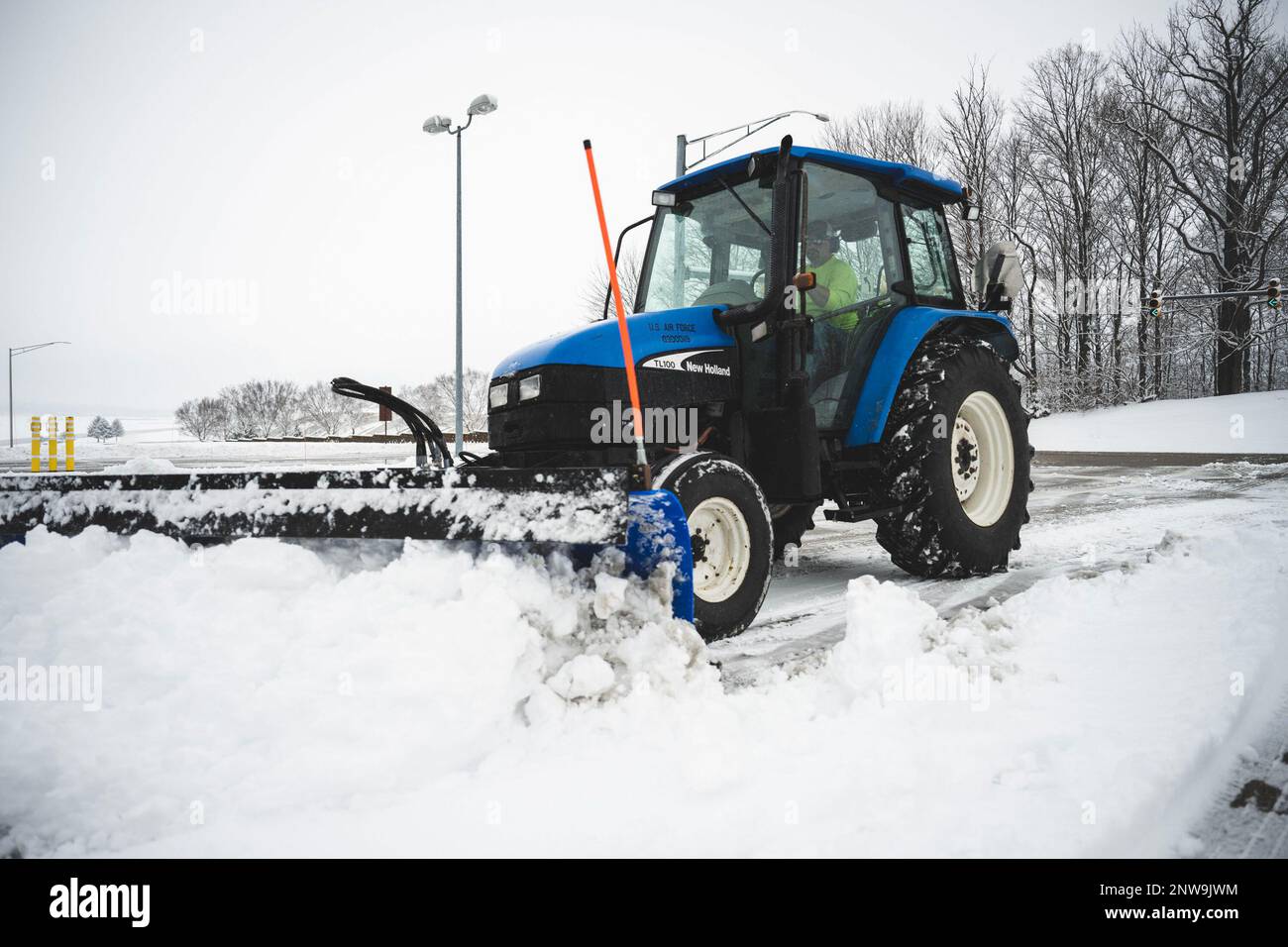 A snowplow operator from the 88th Civil Engineer Squadron clears roads ...