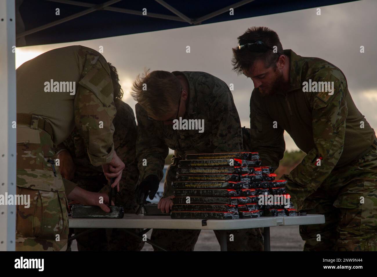 U.S. Marine Corps Chief Warrant Officer 2 Dane Schielke, center, an ...
