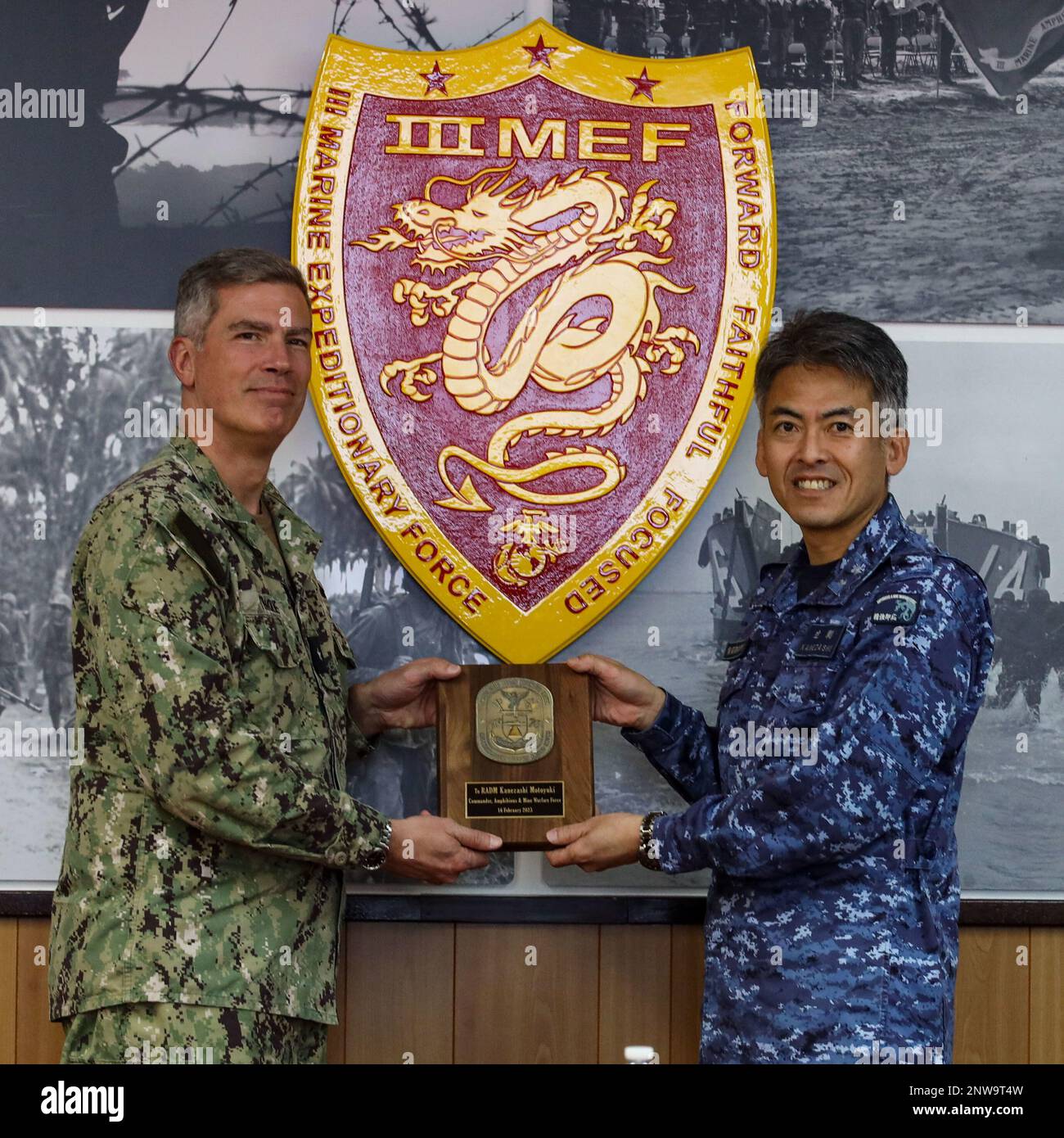 U.S. Navy Rear Adm. Derek Trinque, commander Task Force 76/3, left, and ...
