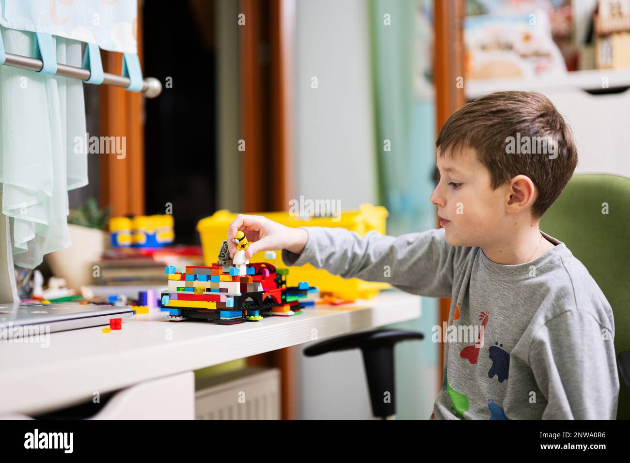 Ternopil, Ukraine - February, 2023: Boy kid constructing toy use Lego ...