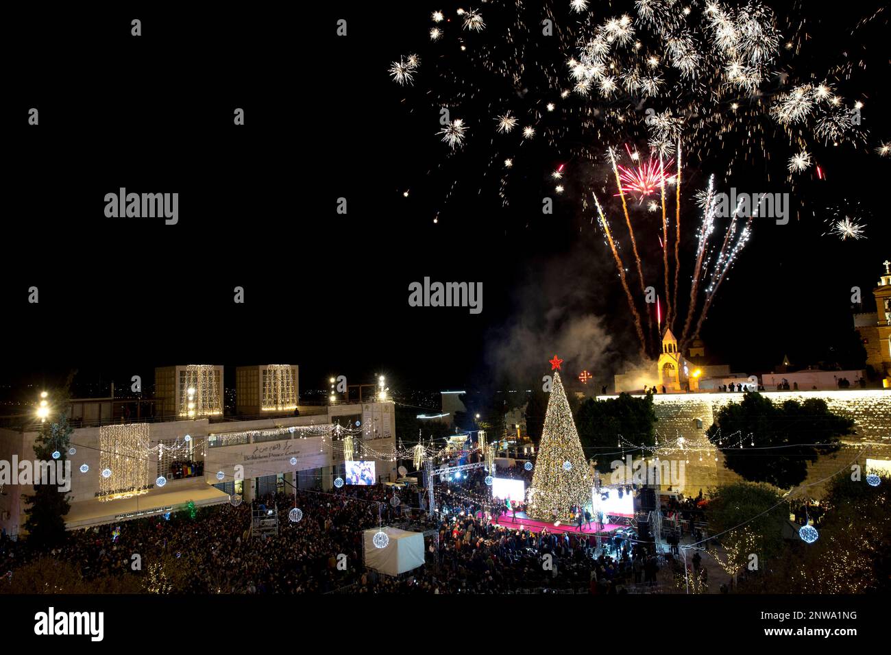 Palestinian Christians celebrate the lighting of a Christmas tree in ...
