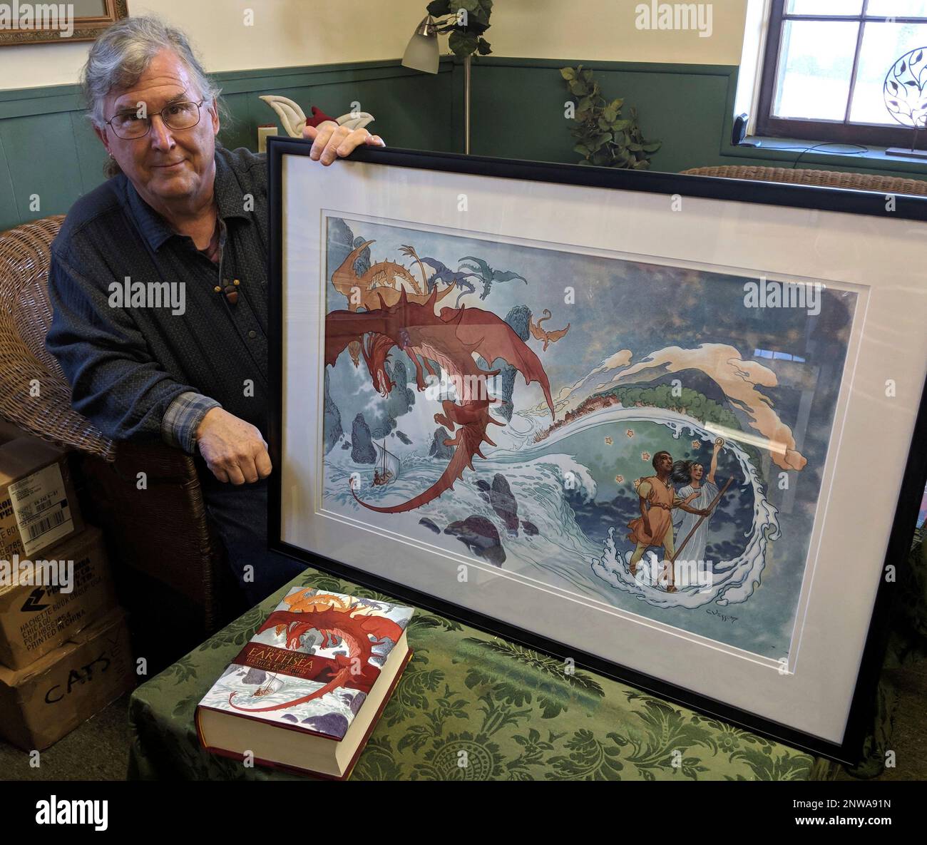 In this undated photo, Charles Vess poses with a framed picture of the ...
